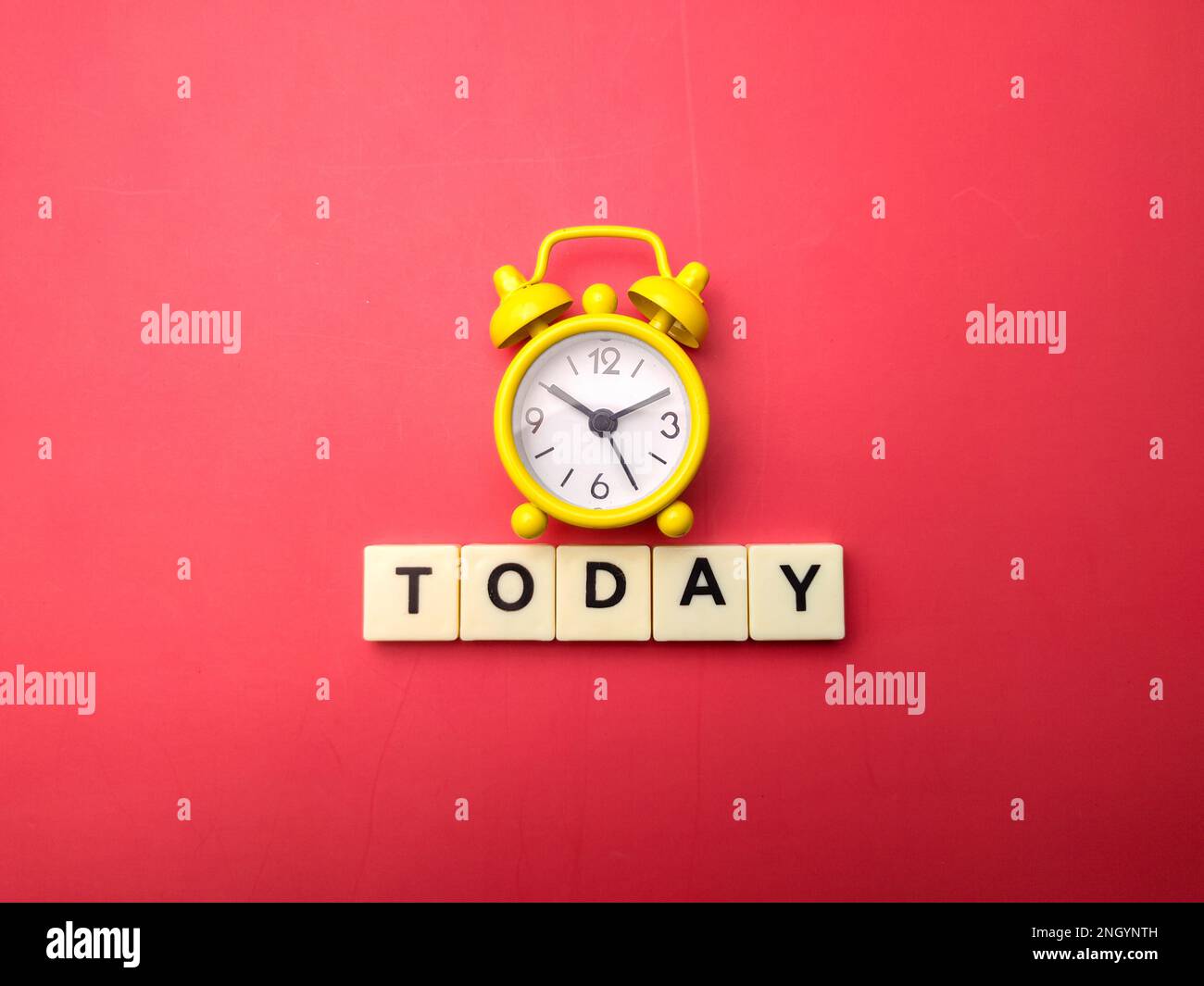 Yellow alarm clock with the word TODAY on a red background Stock Photo ...
