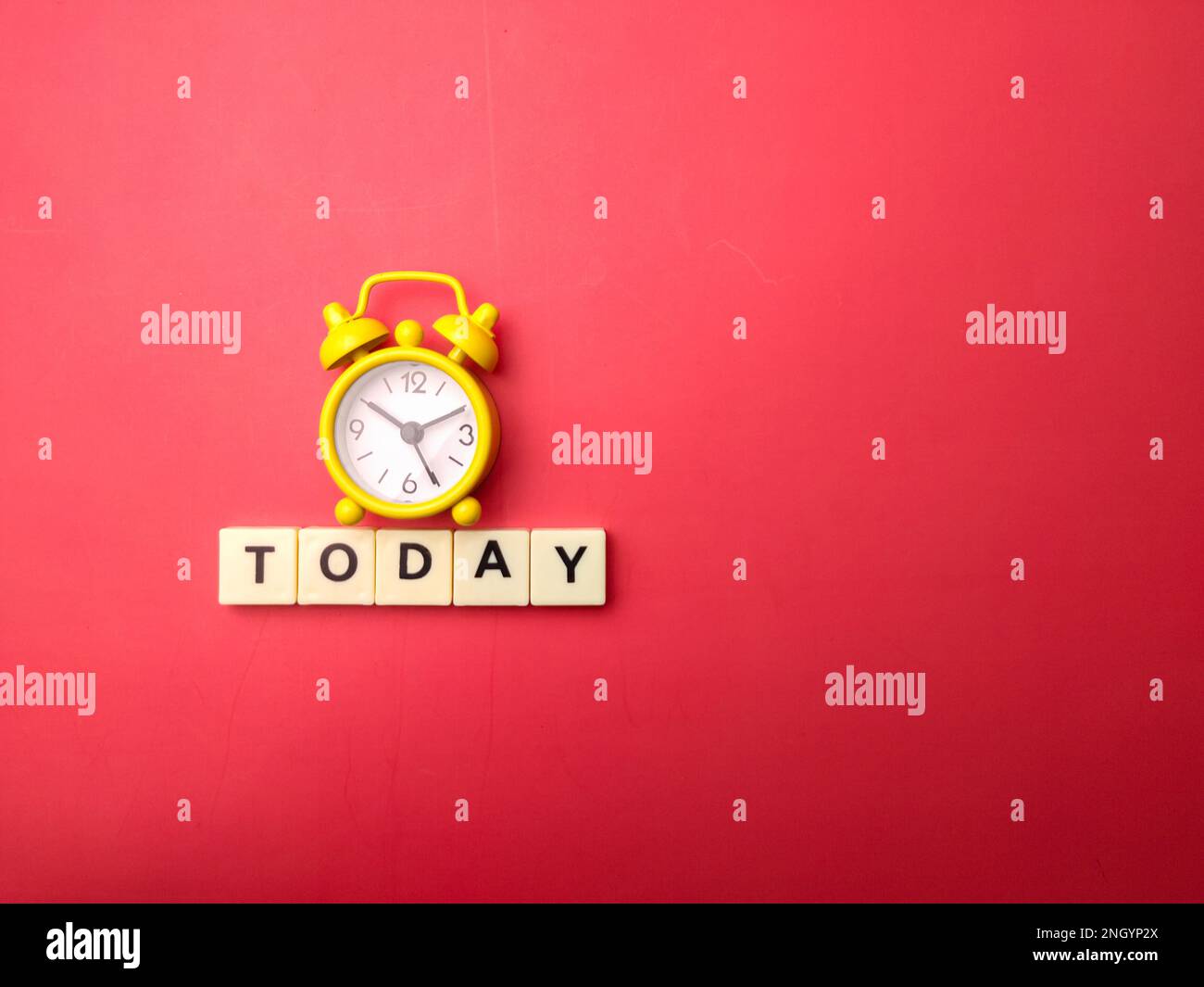 Yellow alarm clock with the word TODAY on a red background Stock Photo ...