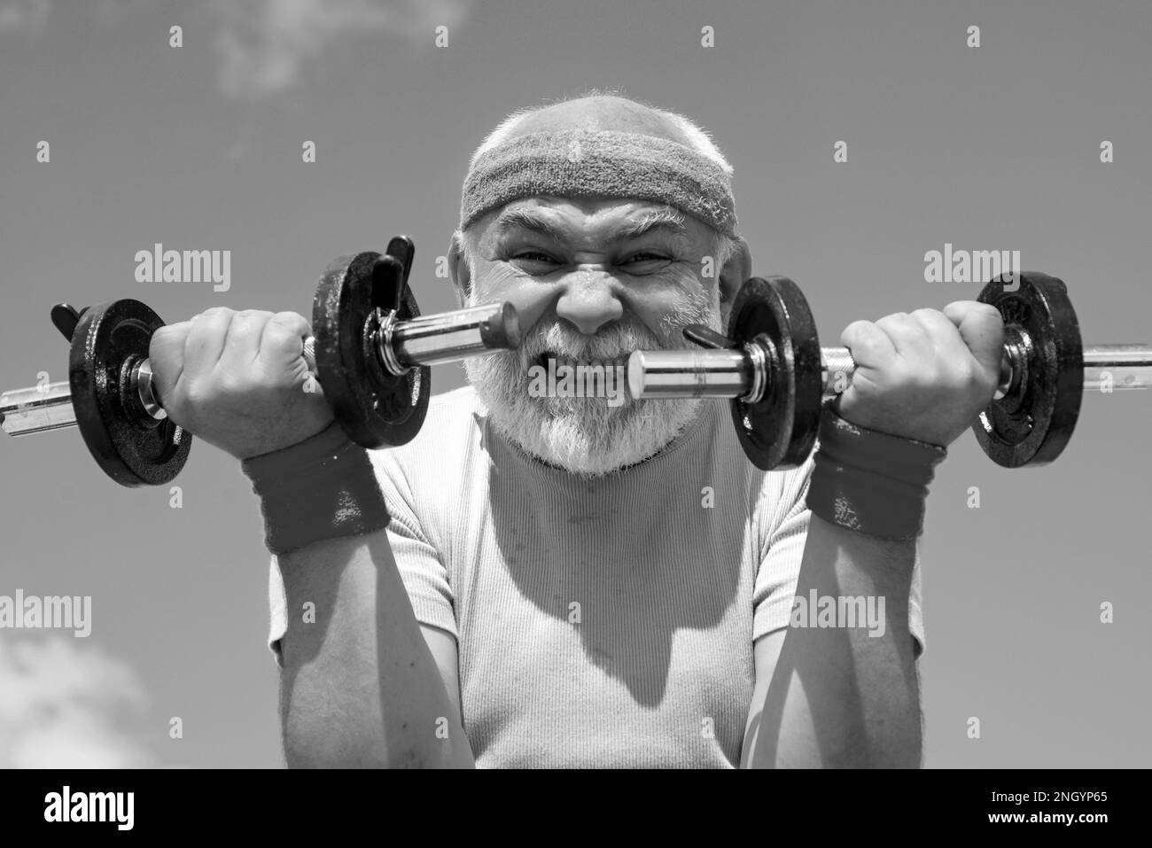 Senior sport man lifting dumbbells in sport center. Health club or ...