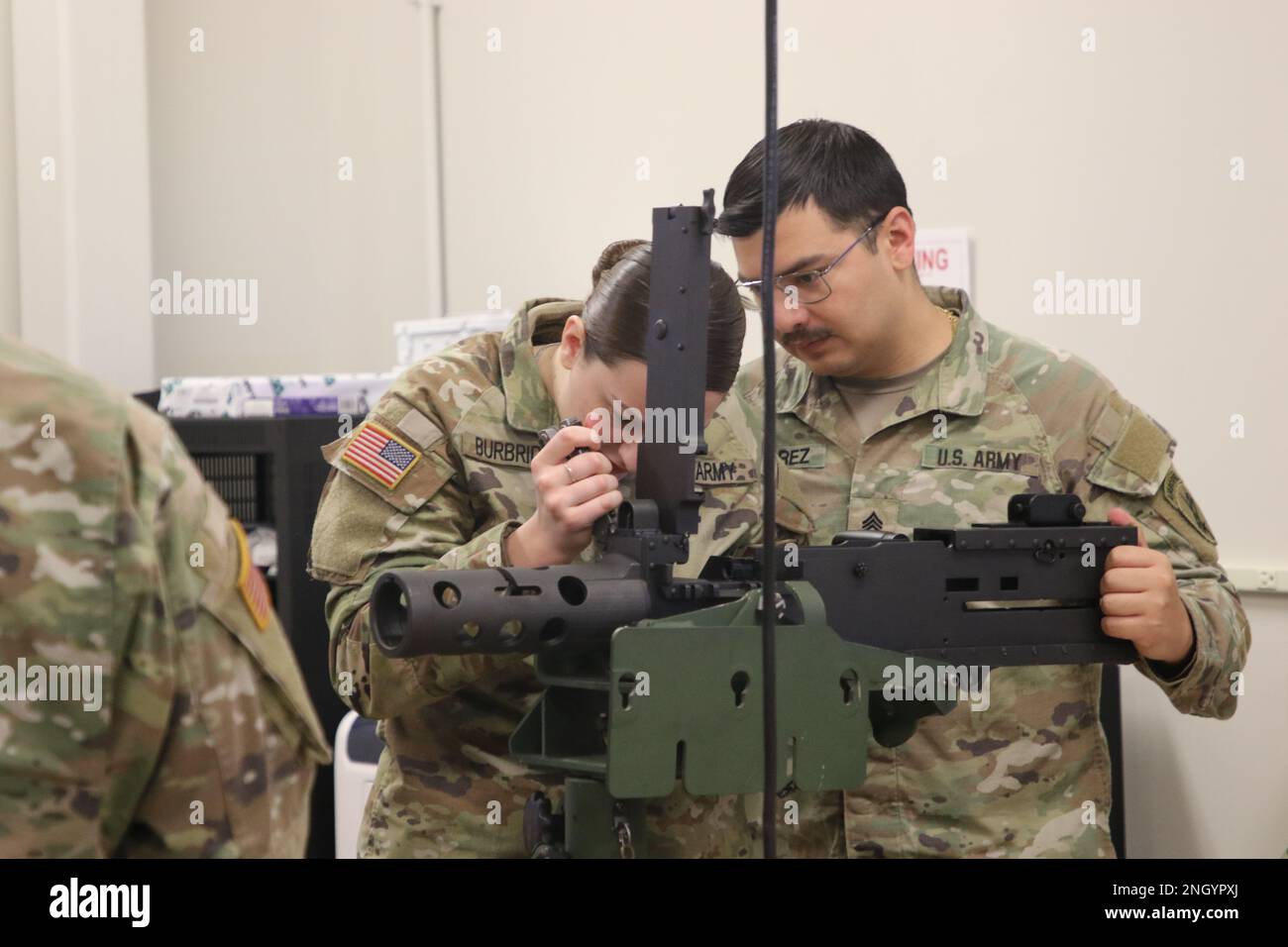 Sgt. Mariano Alvarez assist Spc. Emma Burbridge with disassembling the ...