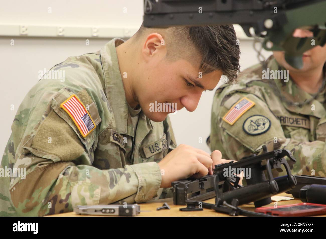 Pfc. Felix Granados breaks down the bolt for the M2 Machine Gun. During ...
