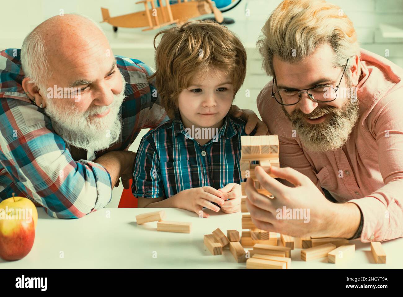 Male generations friendship. Grandfather teaching grandson how to play ...