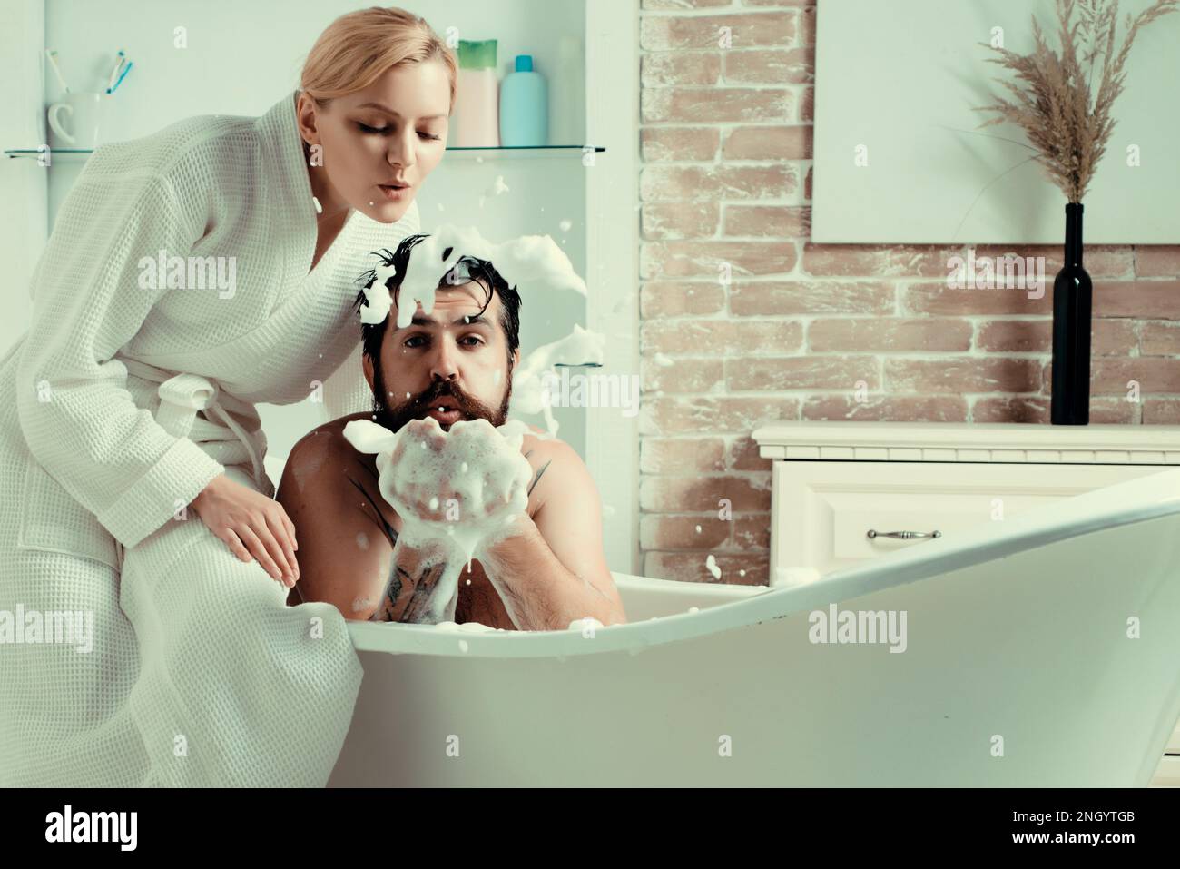 Happy young couple in bathroom at home. Showering person at home lifestyle. Happy young couple ...