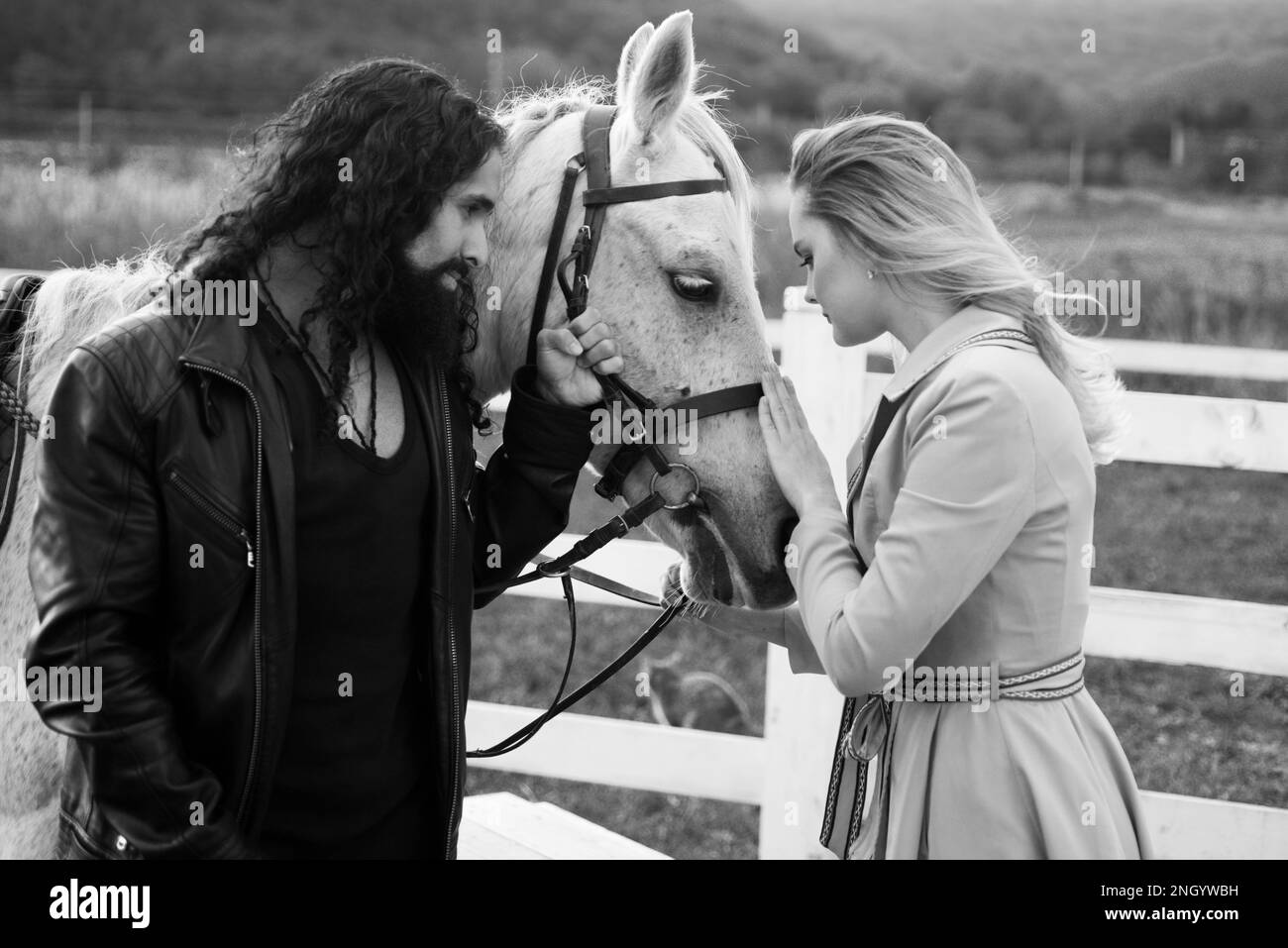 Couple man and woman walking on a ranch with thoroughbred horse ...