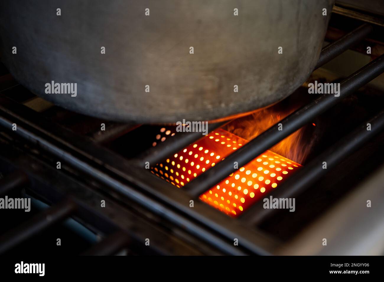 A pot of sauce heats over a burner during dinner preparation for ...