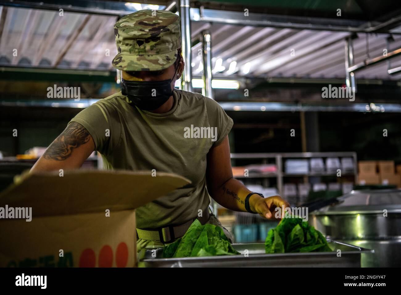 Spc. Rutchelle Auguste, 35th Combat Sustainment Support Battalion culinary specialist, grabs ...