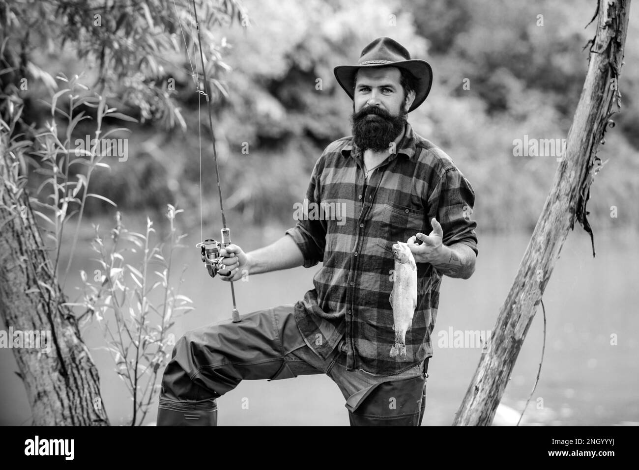 Fish on hook. Men fishing relaxing while enjoying hobby. Cheerful ...