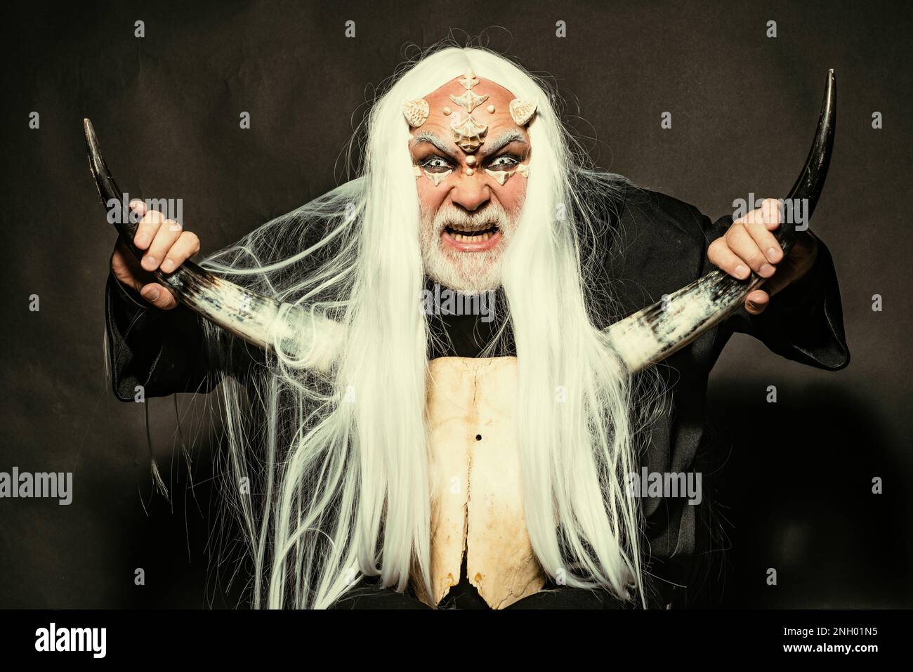 Druid on black background. Alien with dragon skin and grey beard ...