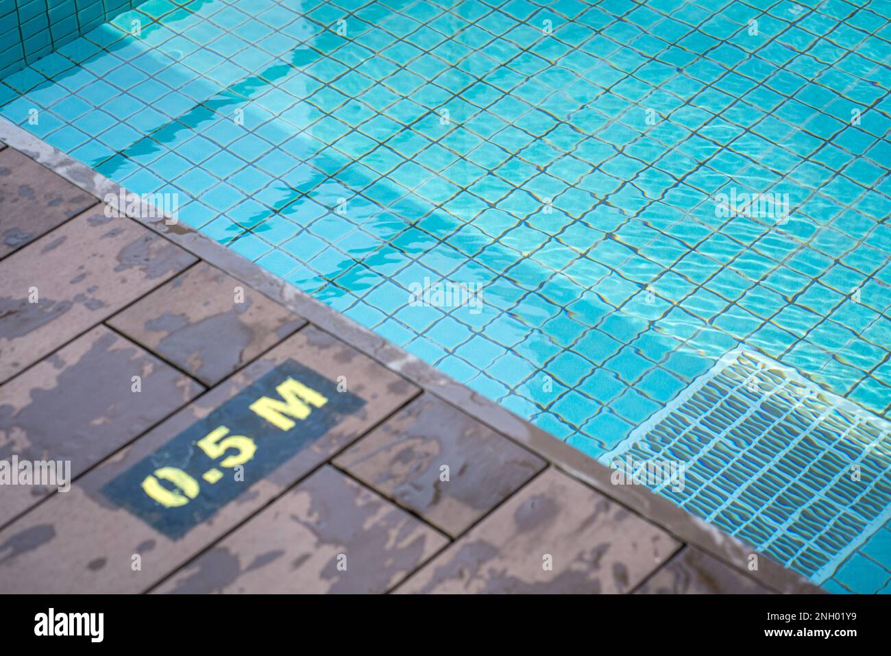 Swimming pool with sign of 0.5m on the floor tiles. Showing the pool ...