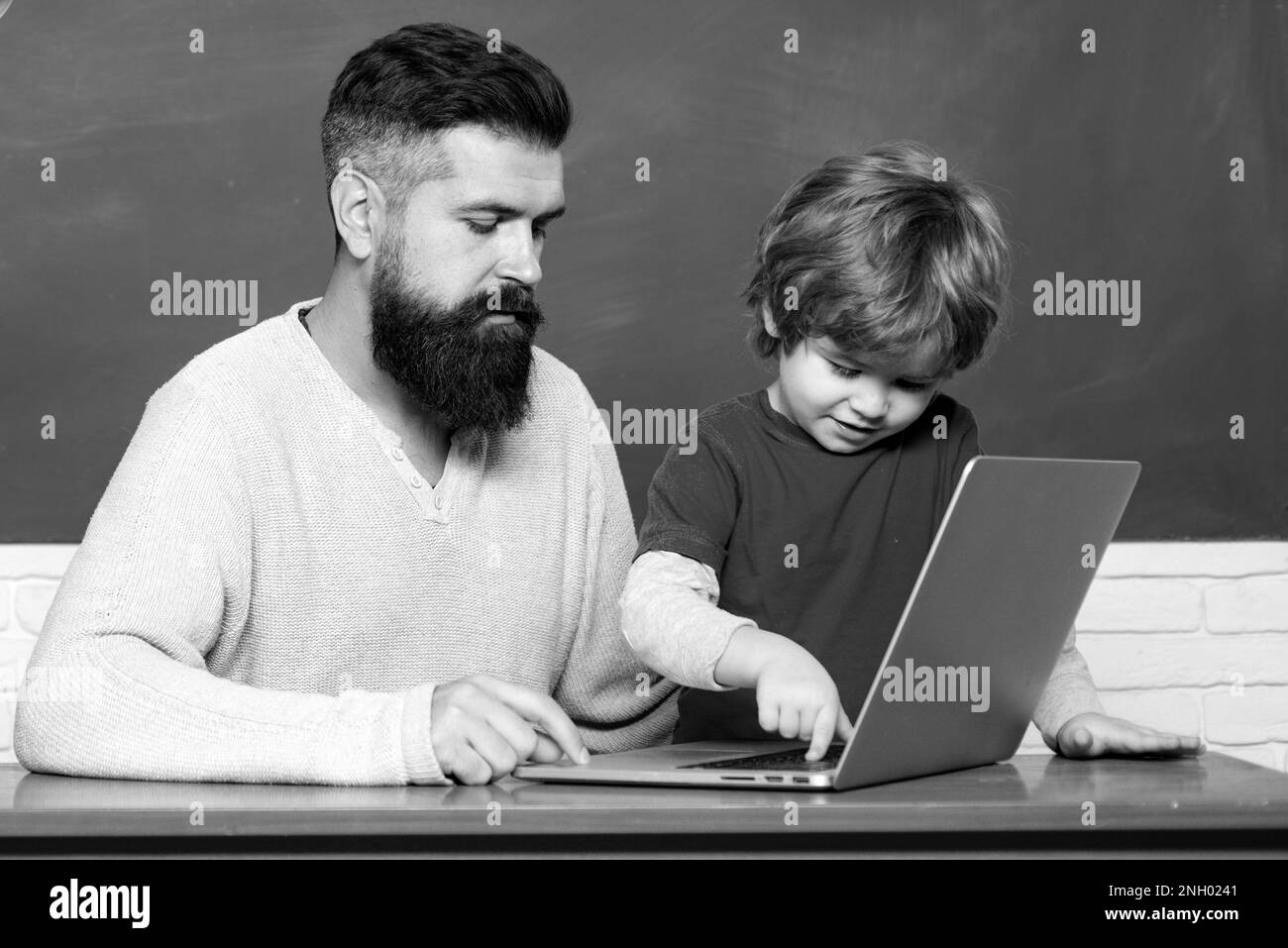 Elementary school teacher and student in classroom. Teacher and ...