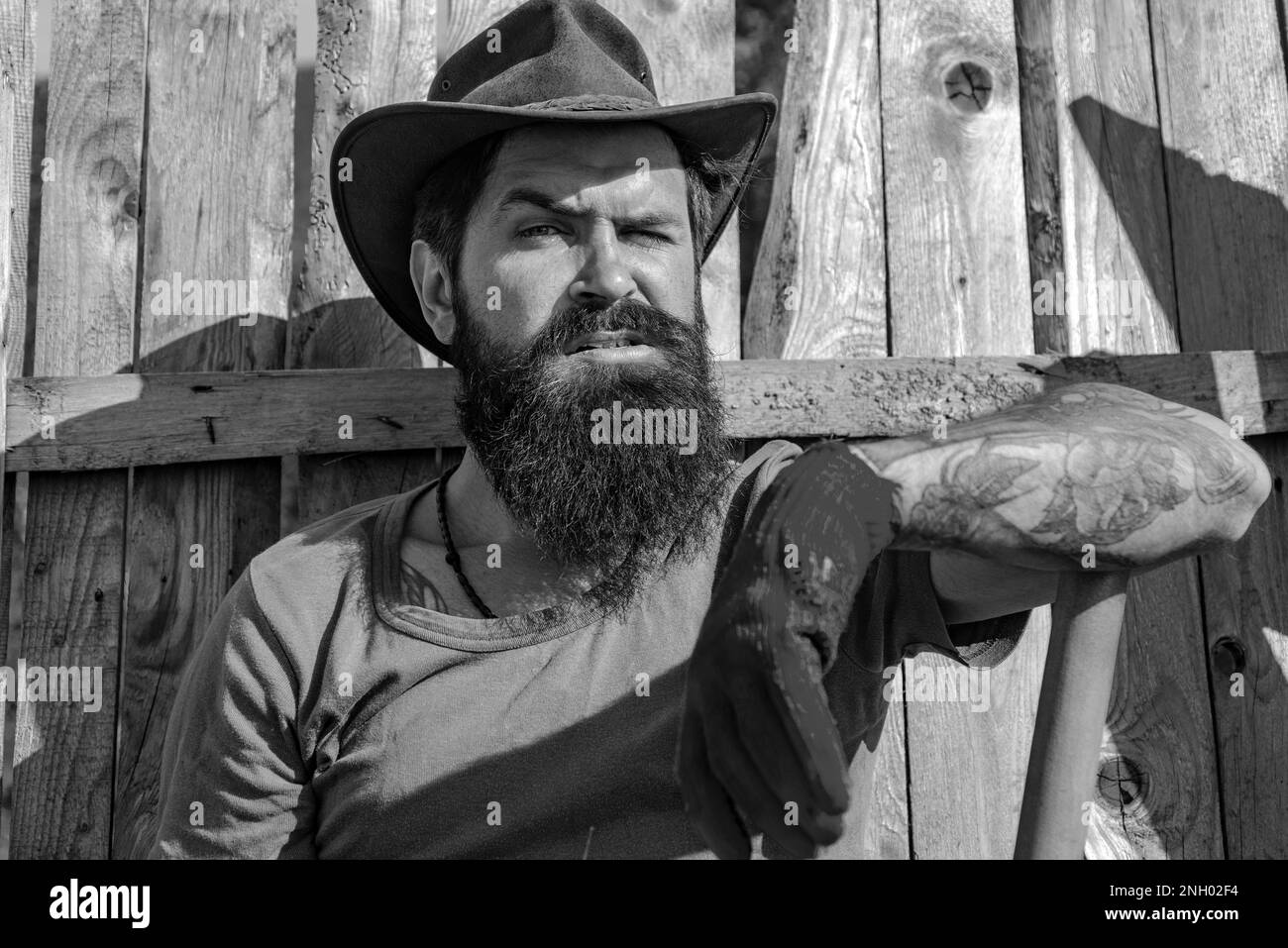 Portrait of father while working in garden. Farmer on farmland ...