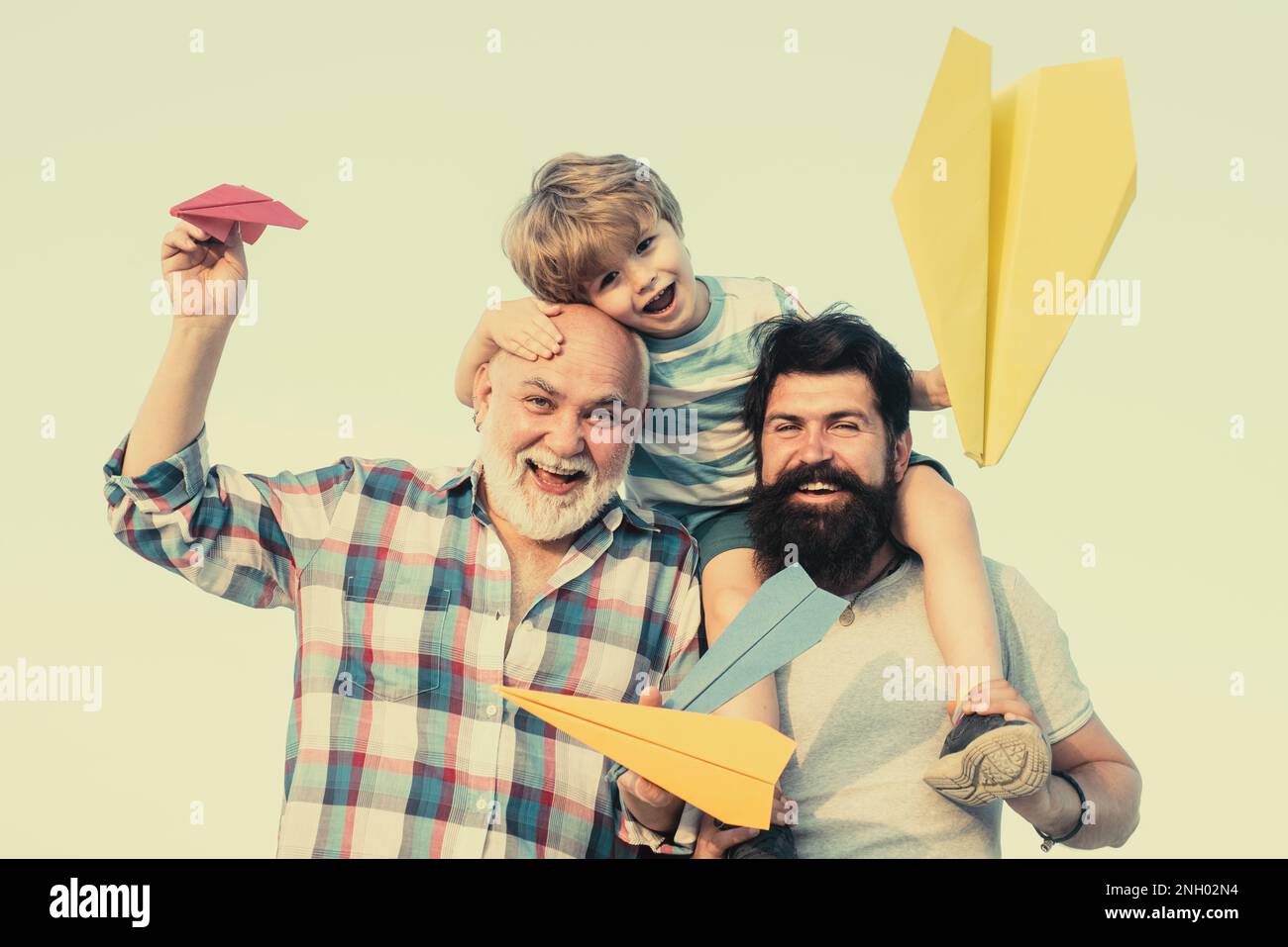 Grandfather, father and son are hugging and having fun together. Kid ...