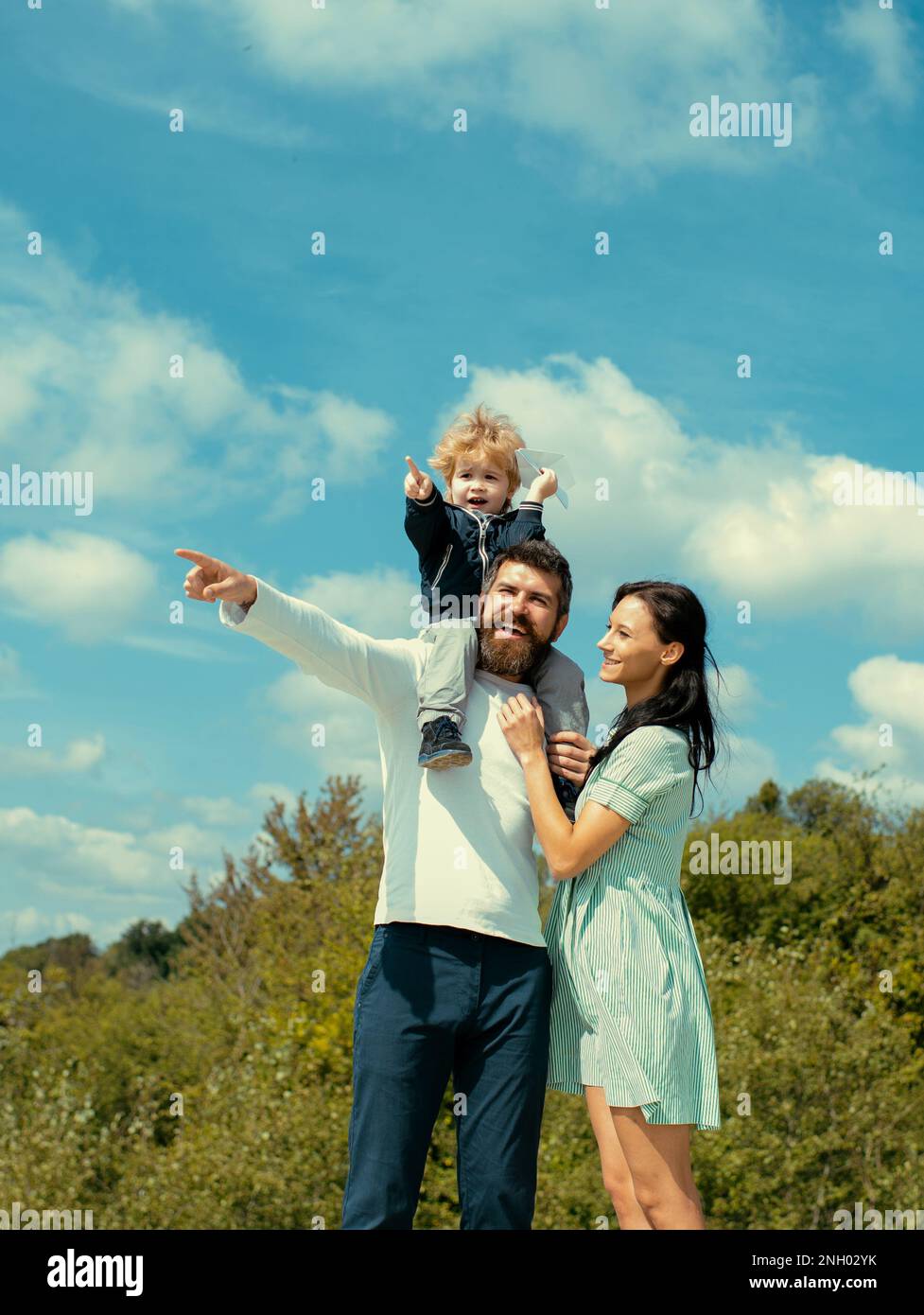 Happy family mother, father and son on sky background in summer. Cute ...
