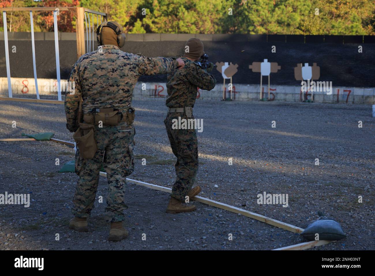 U.S. Marine Corps Sgt. Danny Violante, left, a marksmanship instructor with Weapons Training ...
