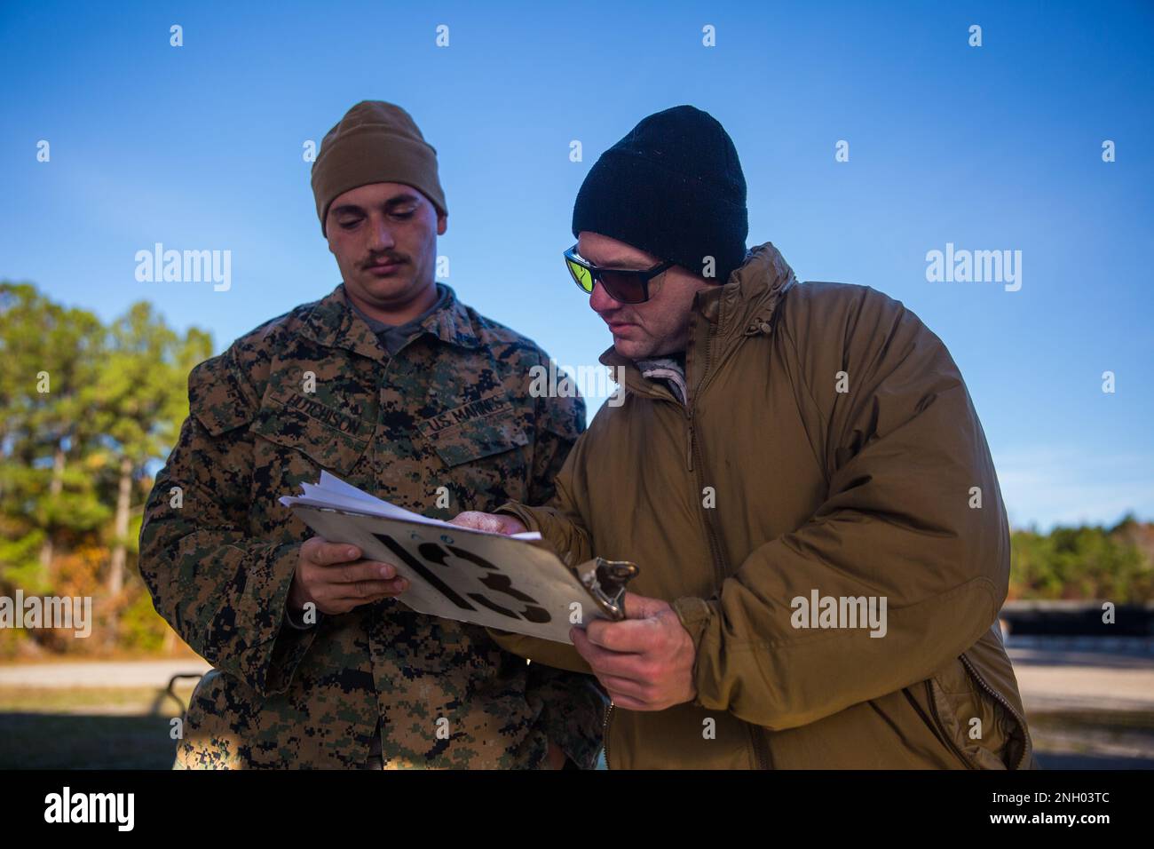 U.S. Marine Corps Lance Cpl. Mike Hutchinson, left, a range coach with ...