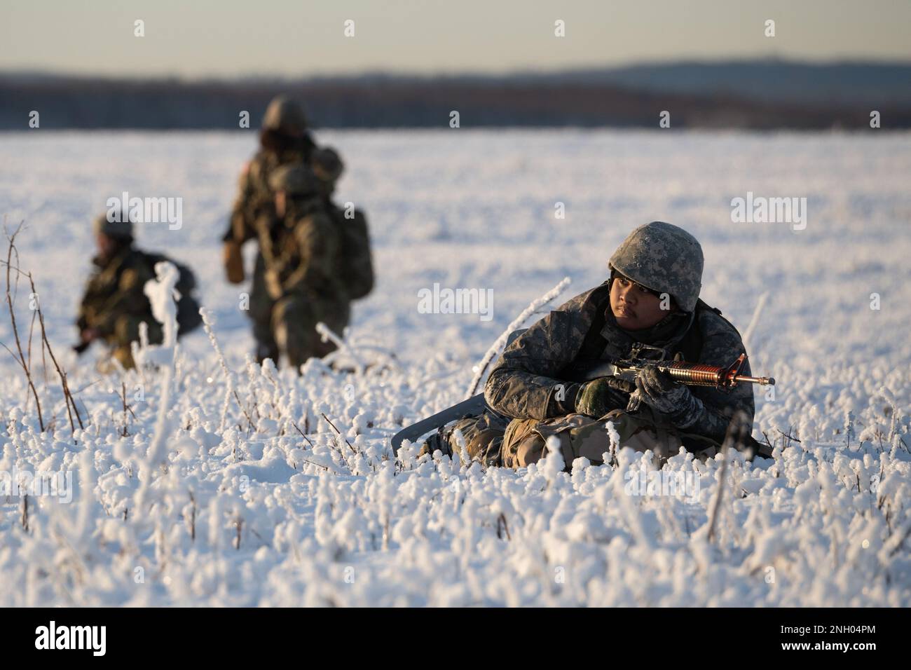 A University of Alaska Army ROTC cadet, foreground, provides security ...