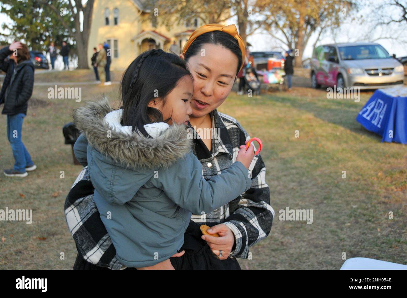 Jen Ancheta and her three-year-old daughter Olive, get a candy cane ...