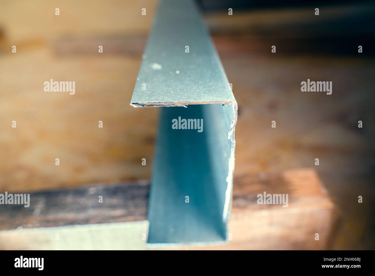 Close-up of a fresh cut of a metal U profile against a blurred ...