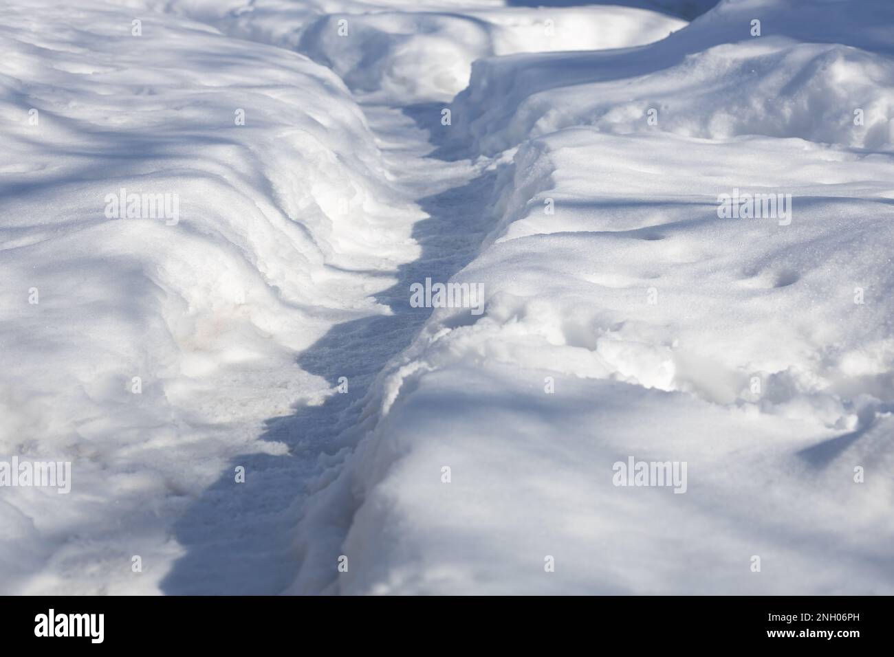 Full frame texture background of a path shoveled in deep snow, just ...