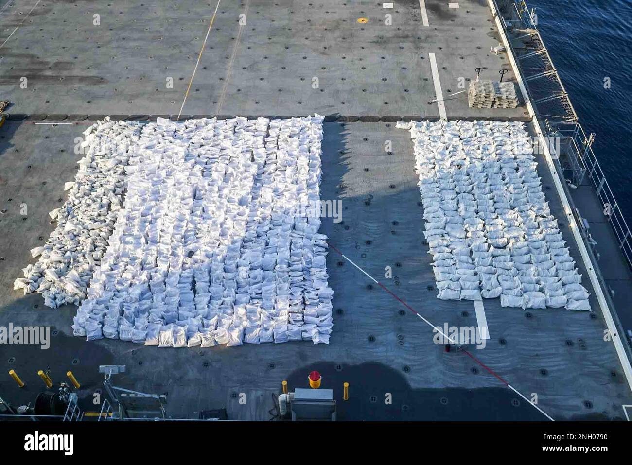 221203-N-NO146-1003 GULF OF OMAN (Dec. 3, 2022) Bags containing more ...