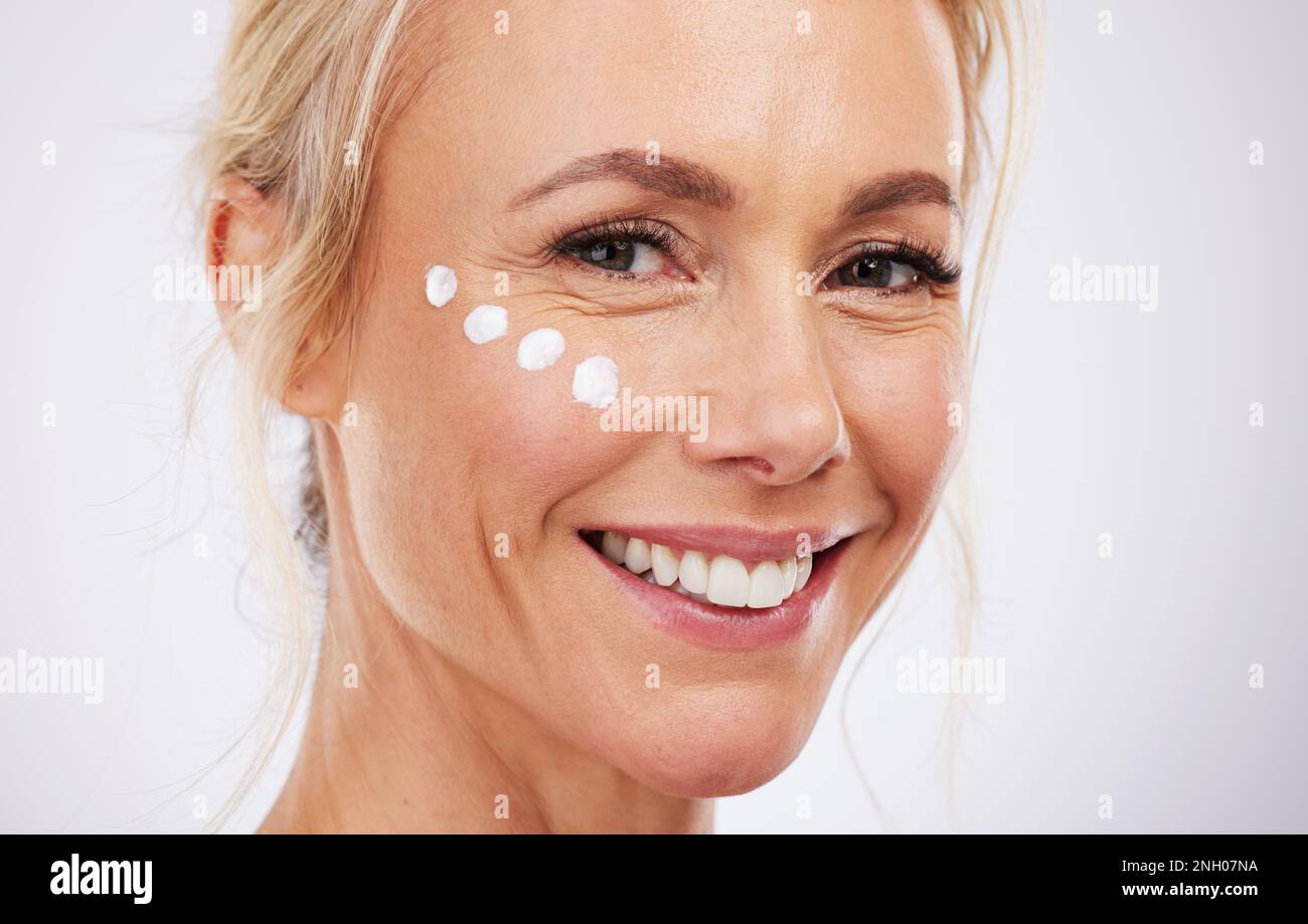 Skincare, face cream and portrait of mature woman in studio for ...