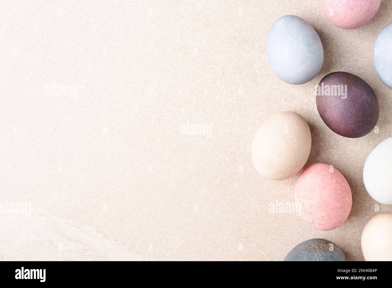 Natural dyed Easter eggs border on beige table. Eco concept, copy space ...