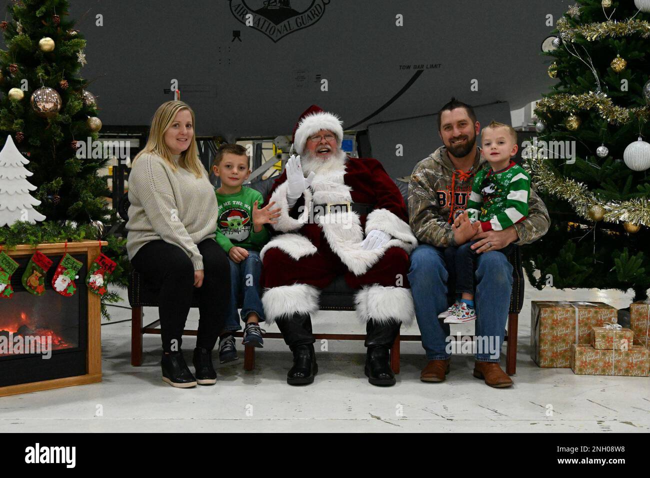 A family with the 126th Air Refueling Wing pose for a photo with Santa ...