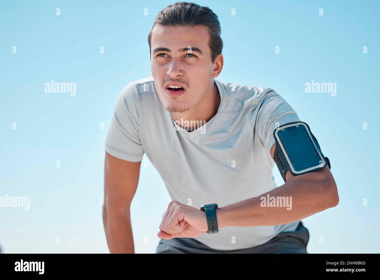 Smart watch, outdoor fitness and man tired from exercise workout ...