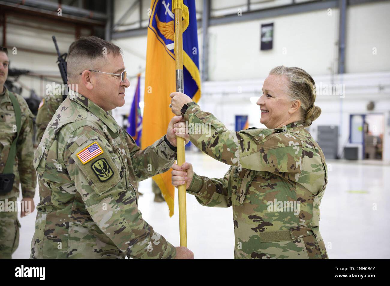 Command Sergeant Major Michael Reilly hands the brigade colors to Col ...