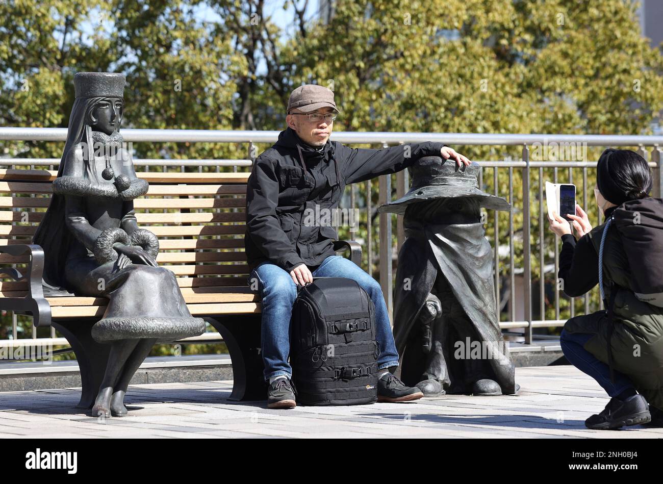 People take pictures with statues of Maetel and Tetsuro near Kokura ...