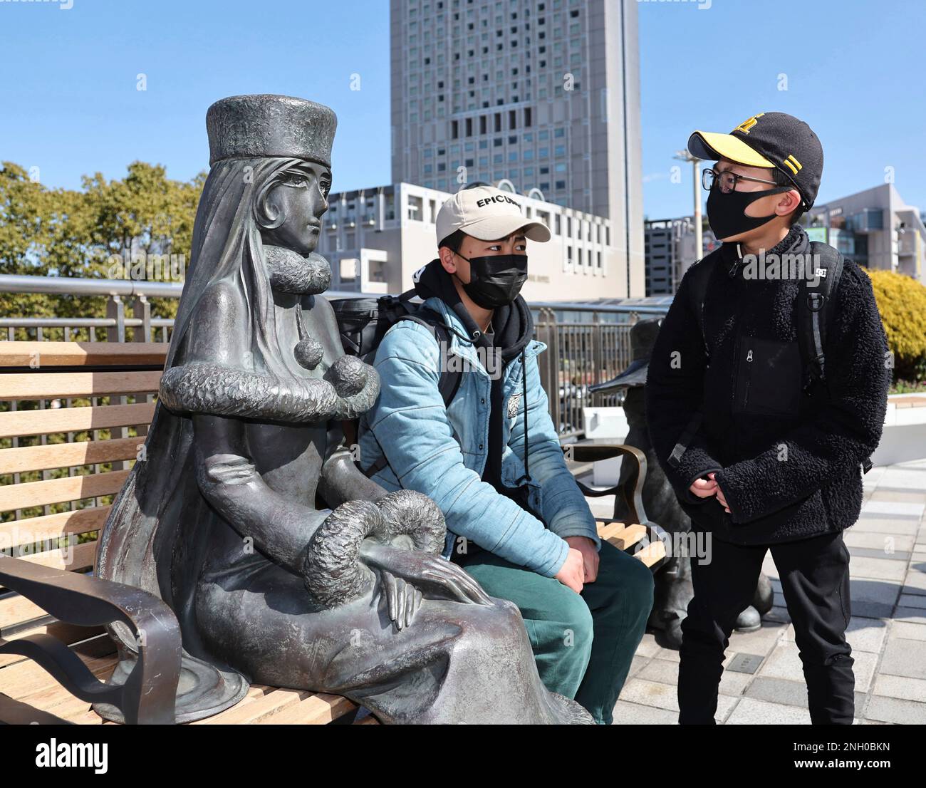 People take pictures with statues of Maetel and Tetsuro near Kokura ...