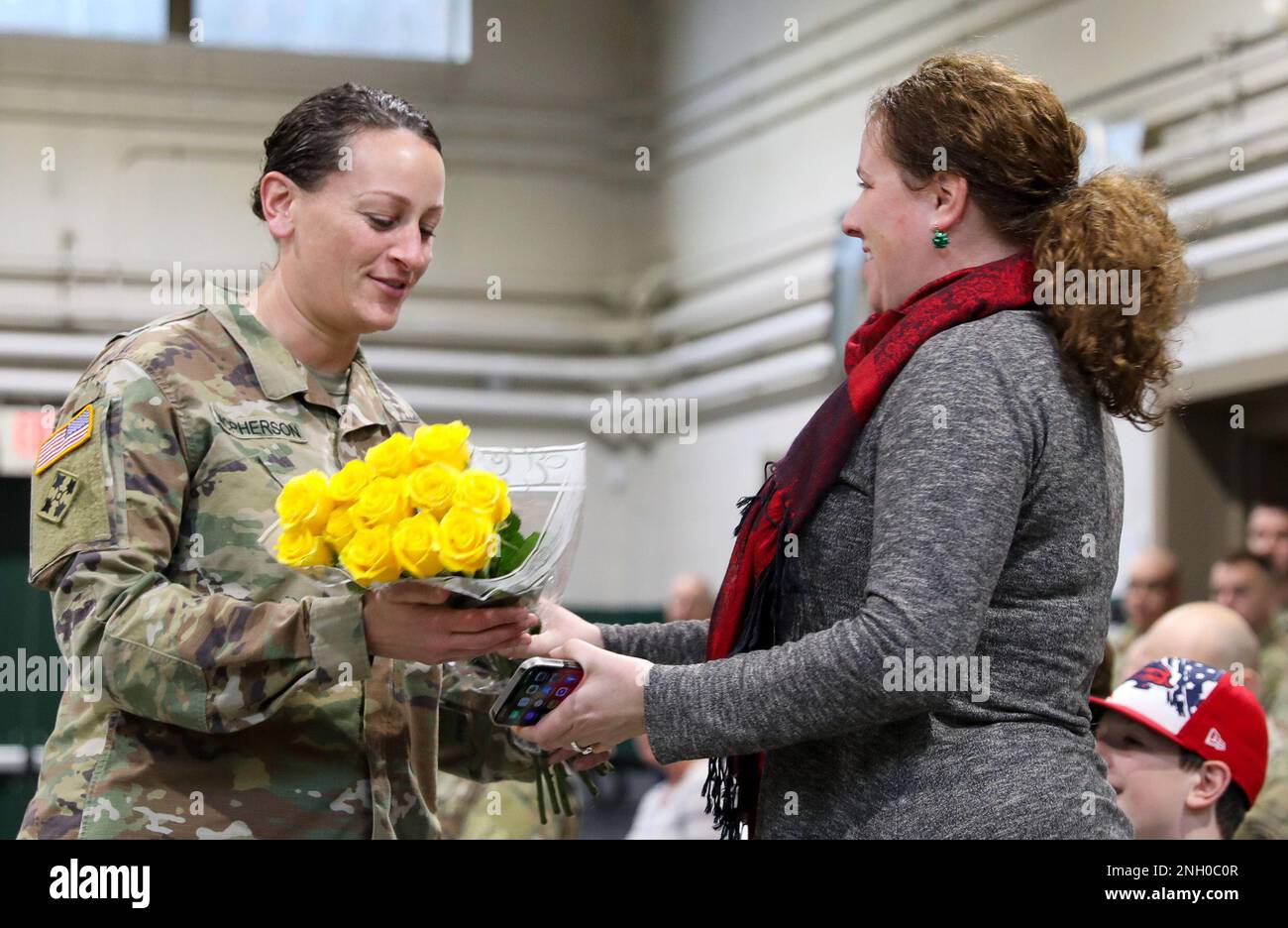 Cheyanne Thompson, wife of Lt. Col Christopher Thompson, is presented a ...
