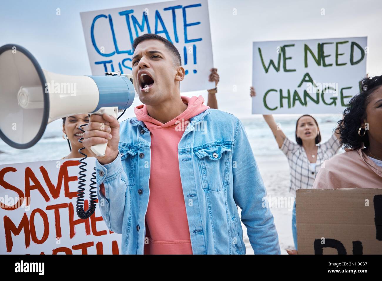 Protest, climate change and megaphone with man at the beach for ...