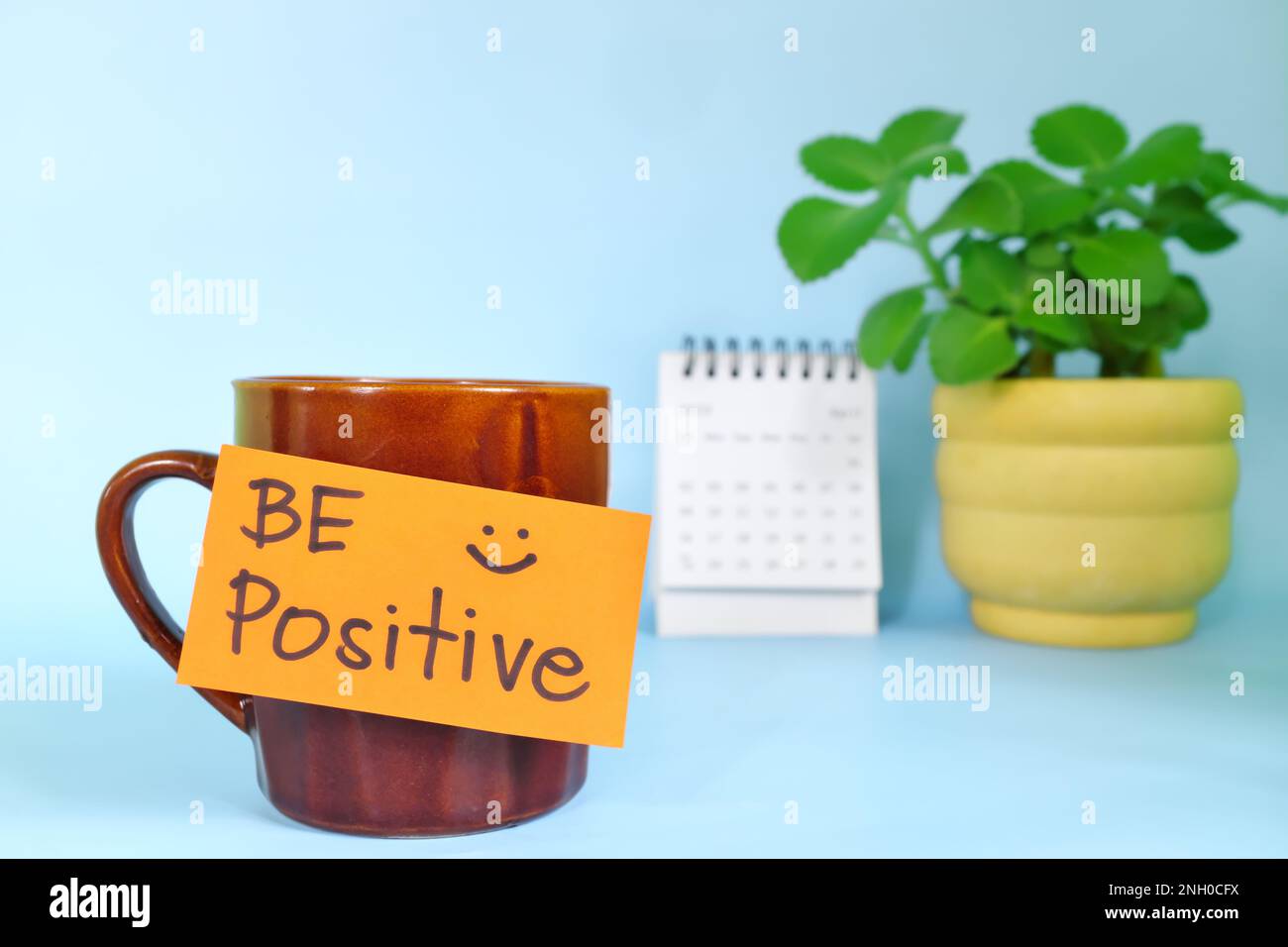 Be positive positivity reminder concept. Selective focus of a cup of ...