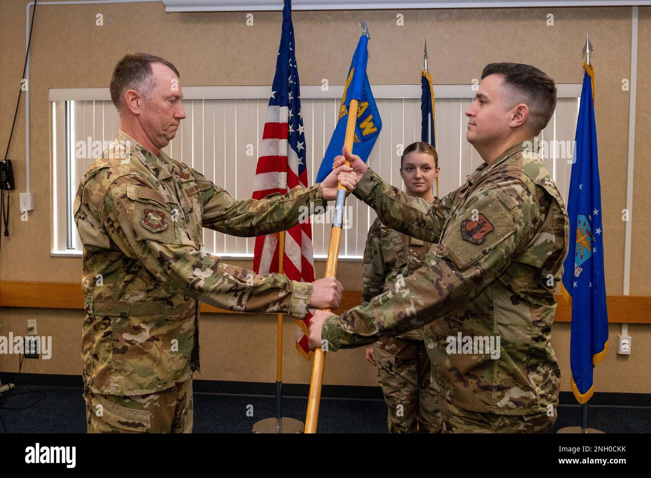 Col. Chris Sigler, commander, 167th Airlift Wing, passes the guideon to Capt. Aaron Hansrote ...