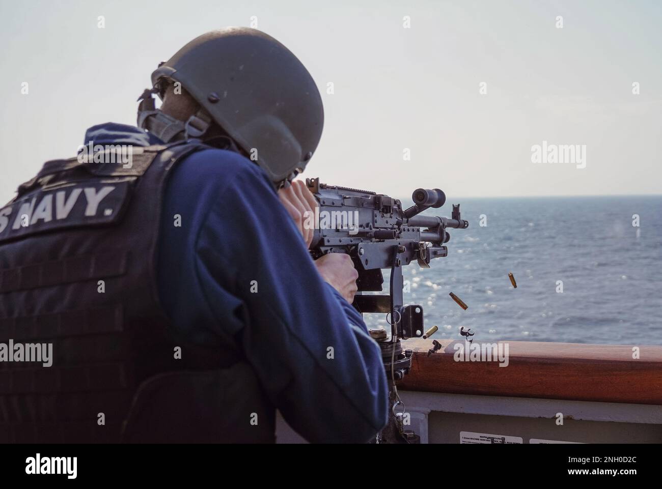 221203-N-EB711-1006 ARABIAN GULF (Dec. 3, 2022) A Sailor shoots an ...
