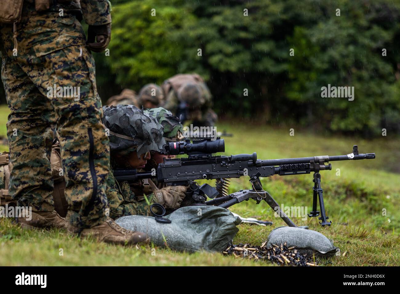 U.S. Marines with Marine Wing Support Squadron (MWSS) 171 fire an M240B ...