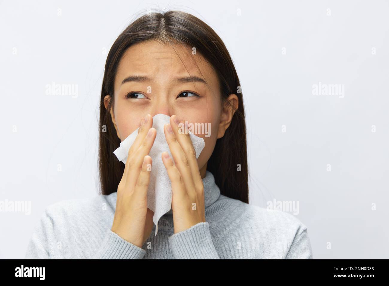 Asian woman holding hand with handkerchief and coughing up flu and cold ...