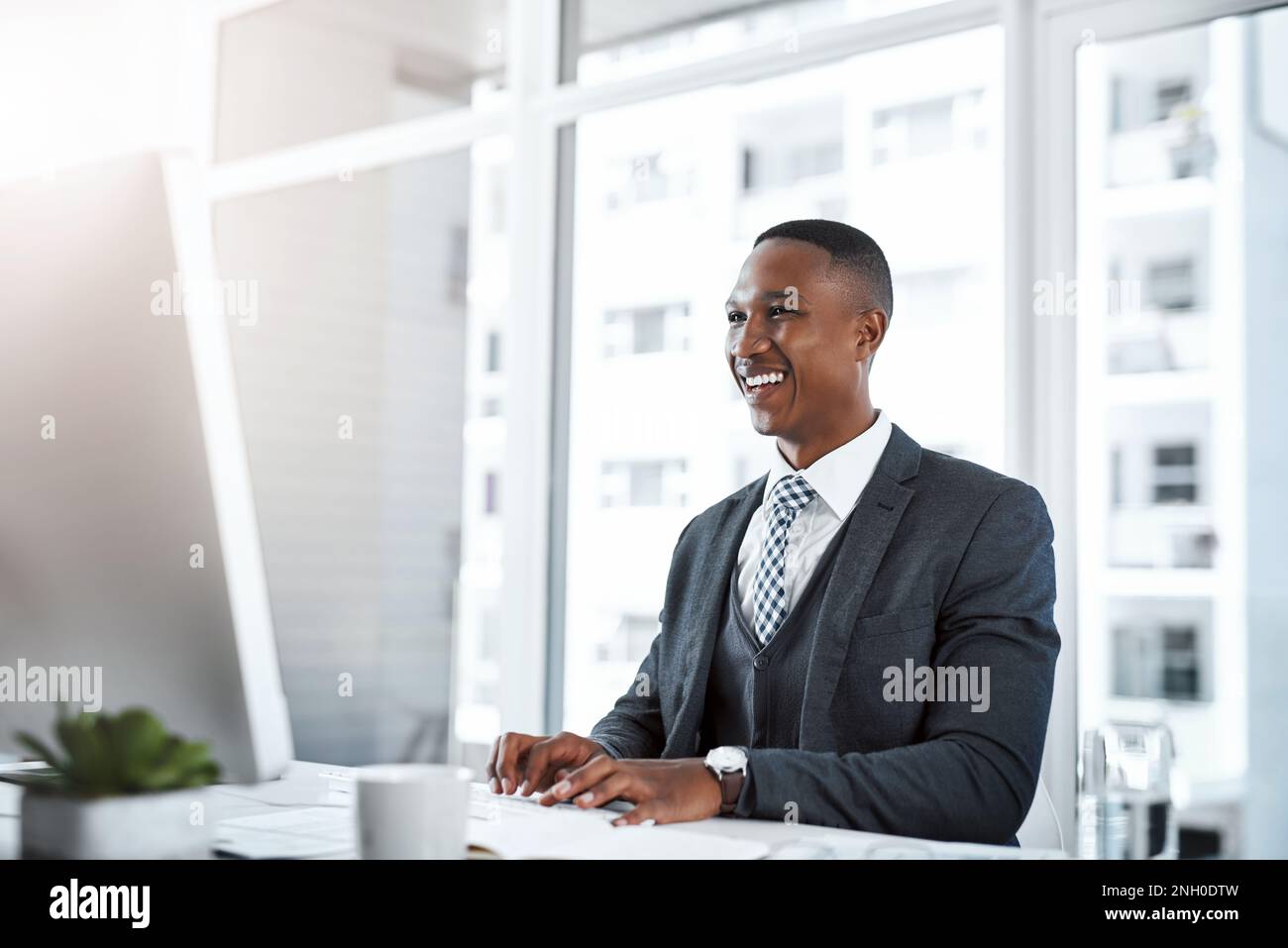 The smile that productivity gave. a young businessman using a computer ...