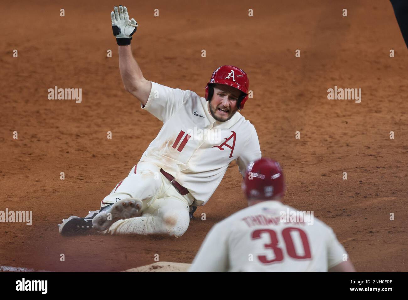 February 19, 2023: Jared Wegner #11 of Arkansas slides safely into ...