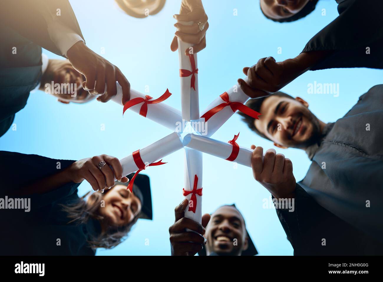 They hold the key to their future. Low angle shot of a group of ...