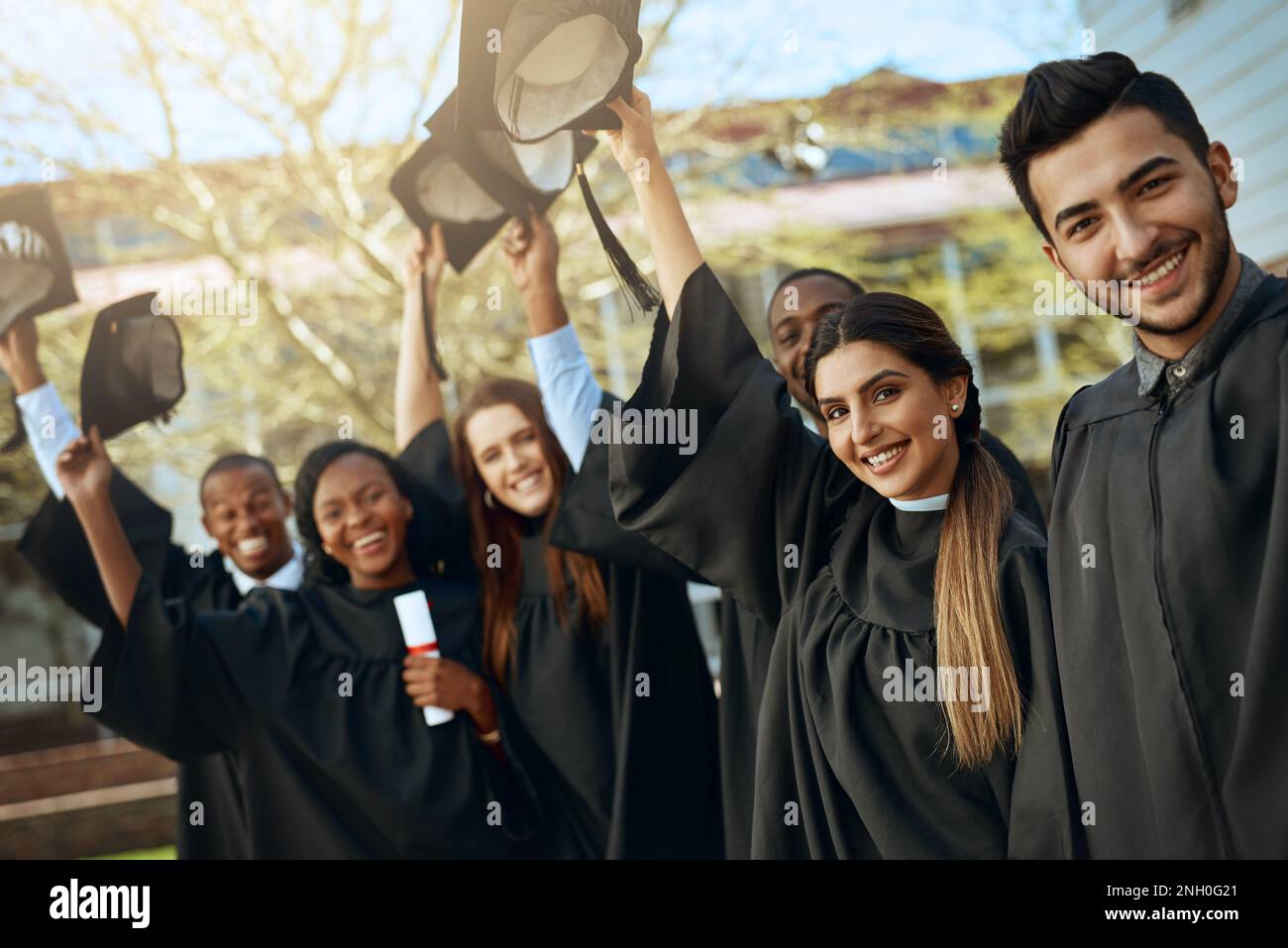 Ready to take on the working world. Portrait of a group of happy young ...
