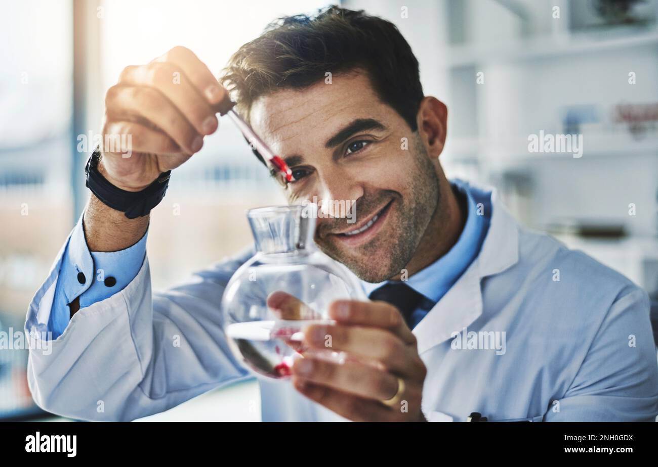 The chemical reaction is just as I expected. a scientist conducting an experiment in a lab Stock ...