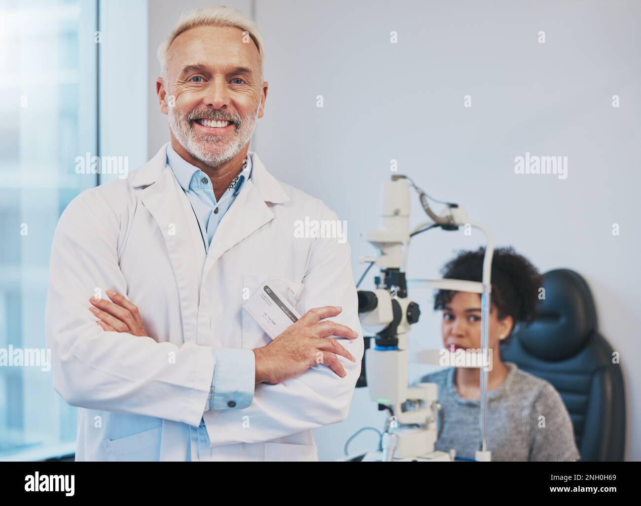 Portrait, man and smile of optometrist with arms crossed in hospital or ...