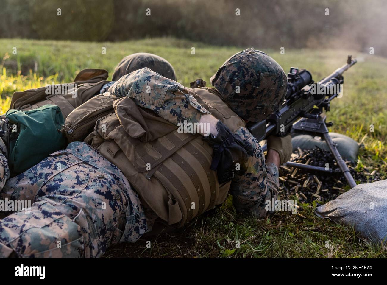 U.S. Marines with Marine Wing Support Squadron (MWSS) 171 fire an M240B ...