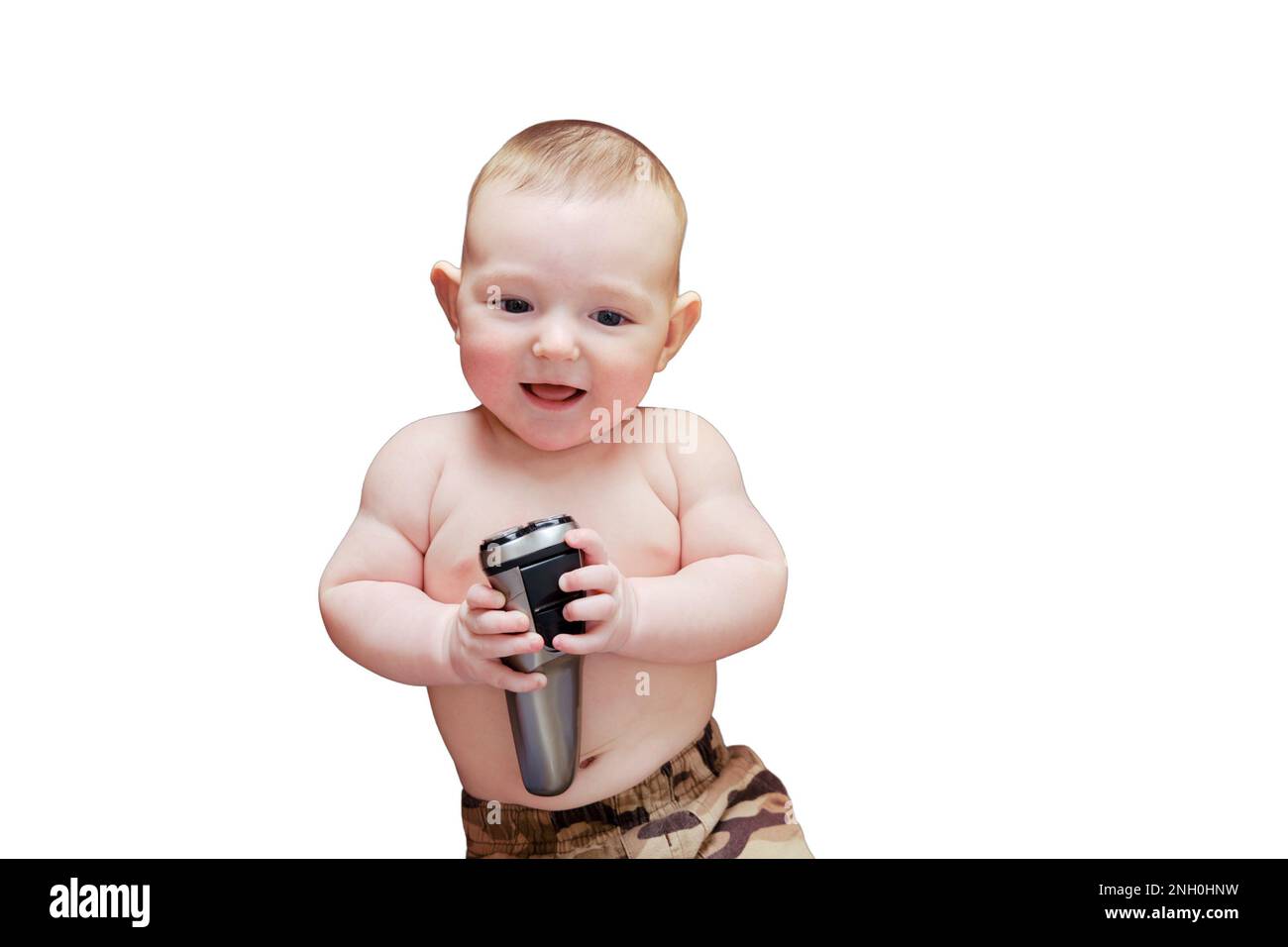 Funny happy baby boy with an electric shaver in his hands. Smiling ...