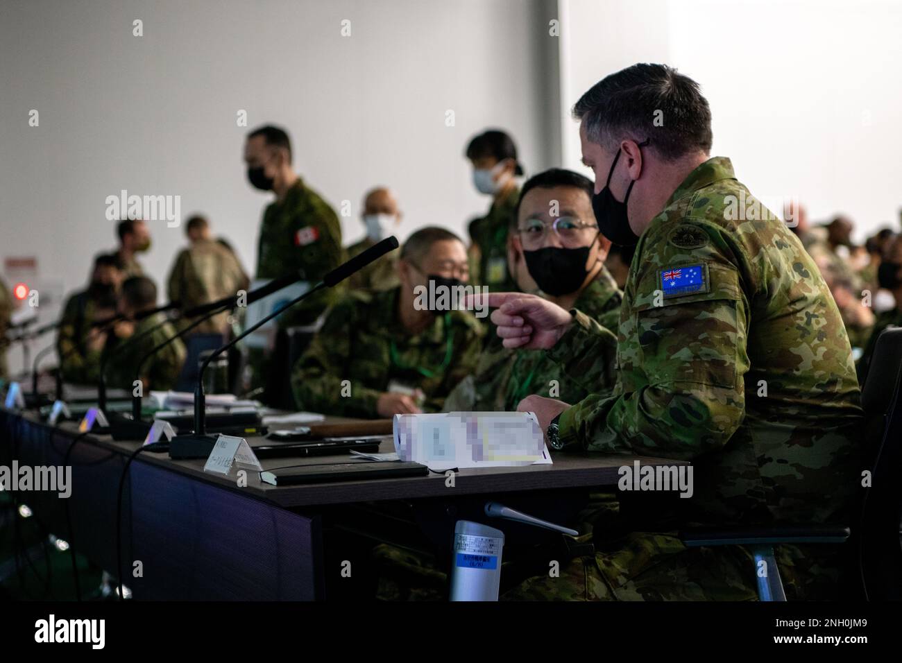 A Japan Ground Self-Defense Force member talks with an Australian Army ...