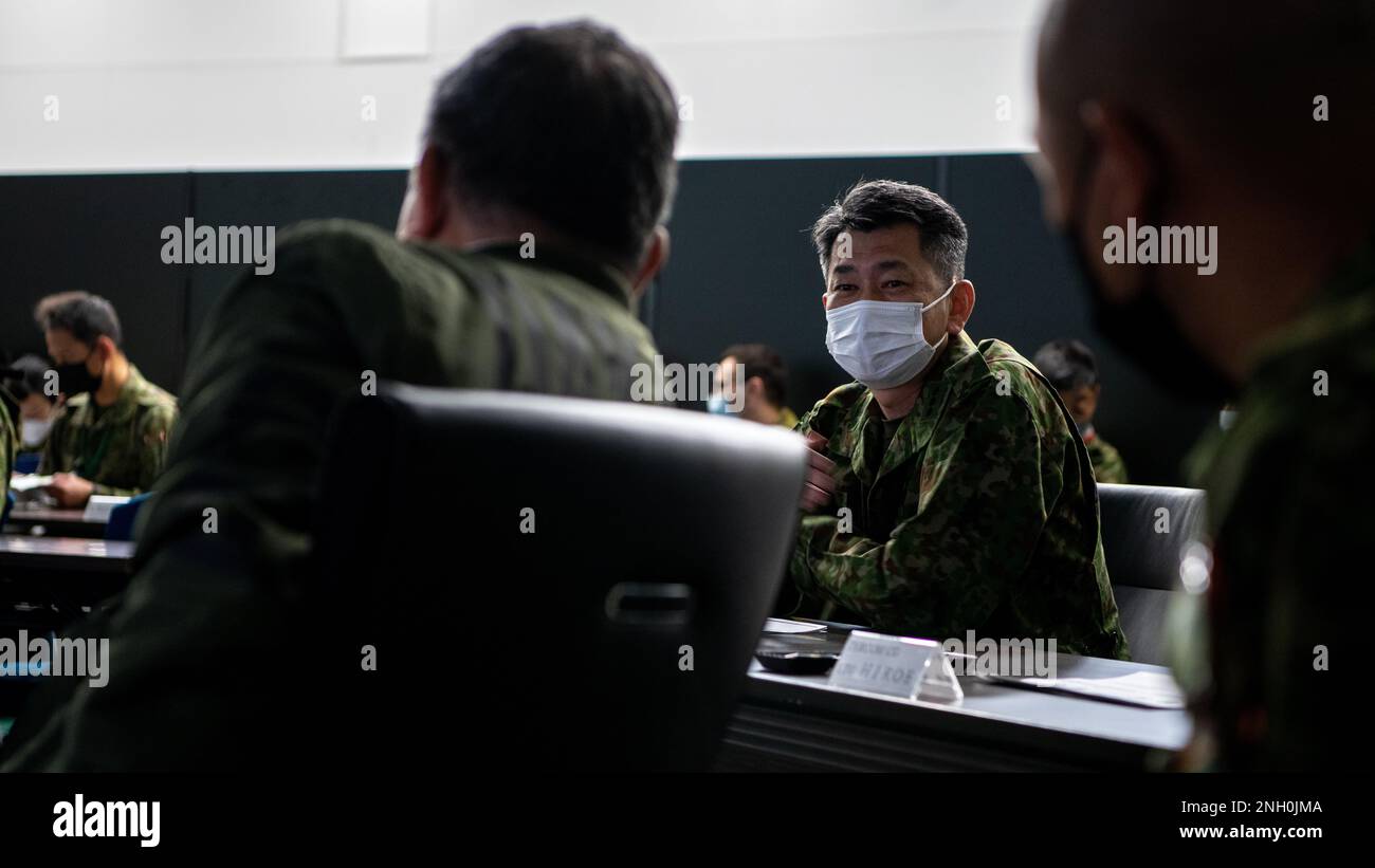 A Japan Ground Self-Defense Force member talks with an Australian Army ...