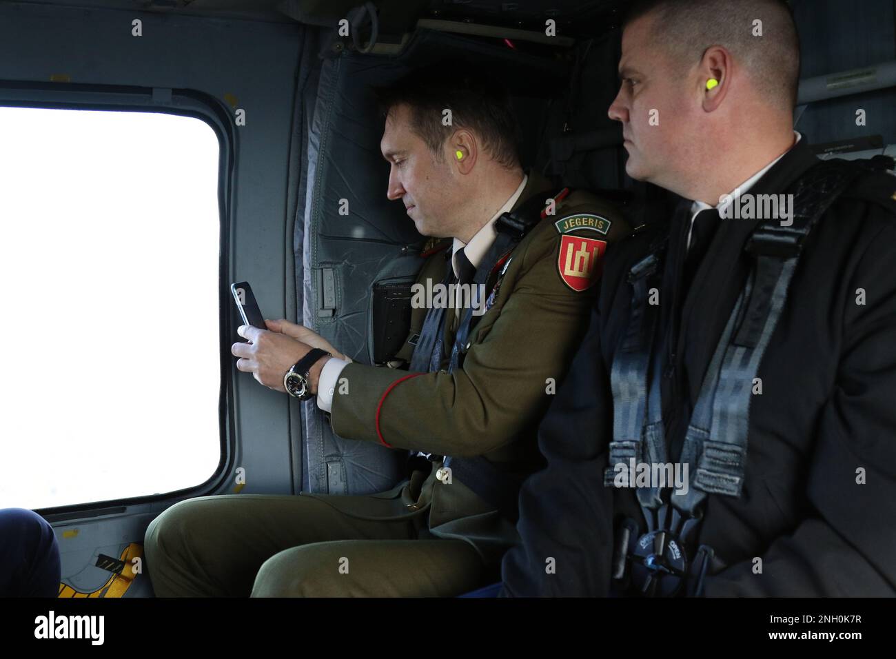 Lithuanian Brig. Gen. Modestas Petrauskas takes a photo out the side of ...