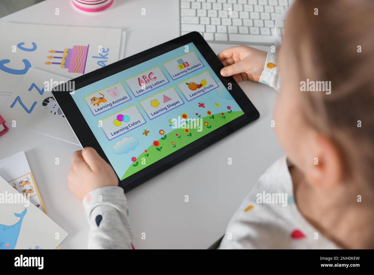 Little girl learning English indoors at online lesson, closeup Stock ...
